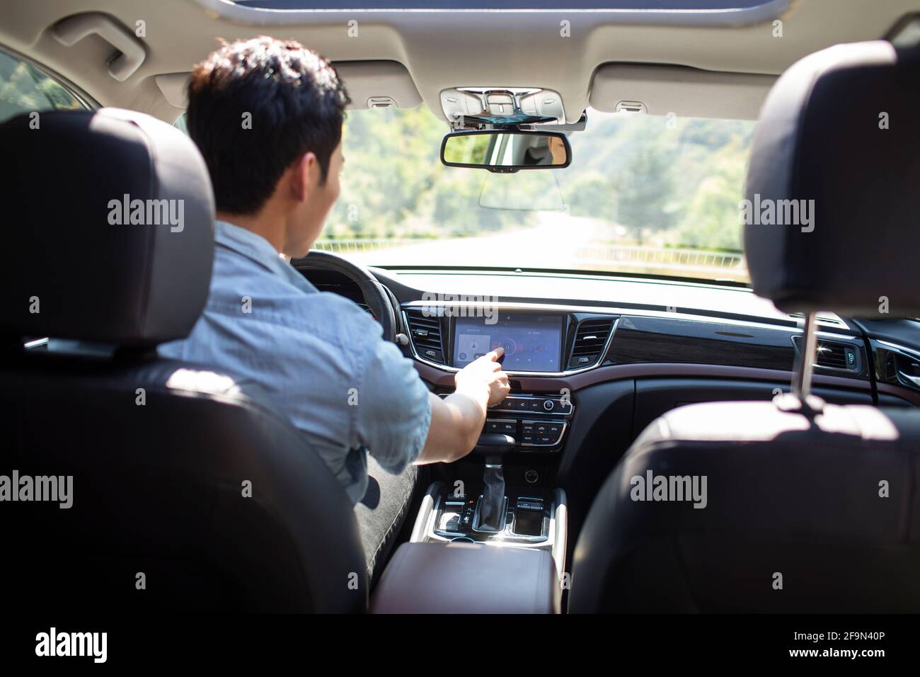 Young man using GPS system in car Stock Photo - Alamy