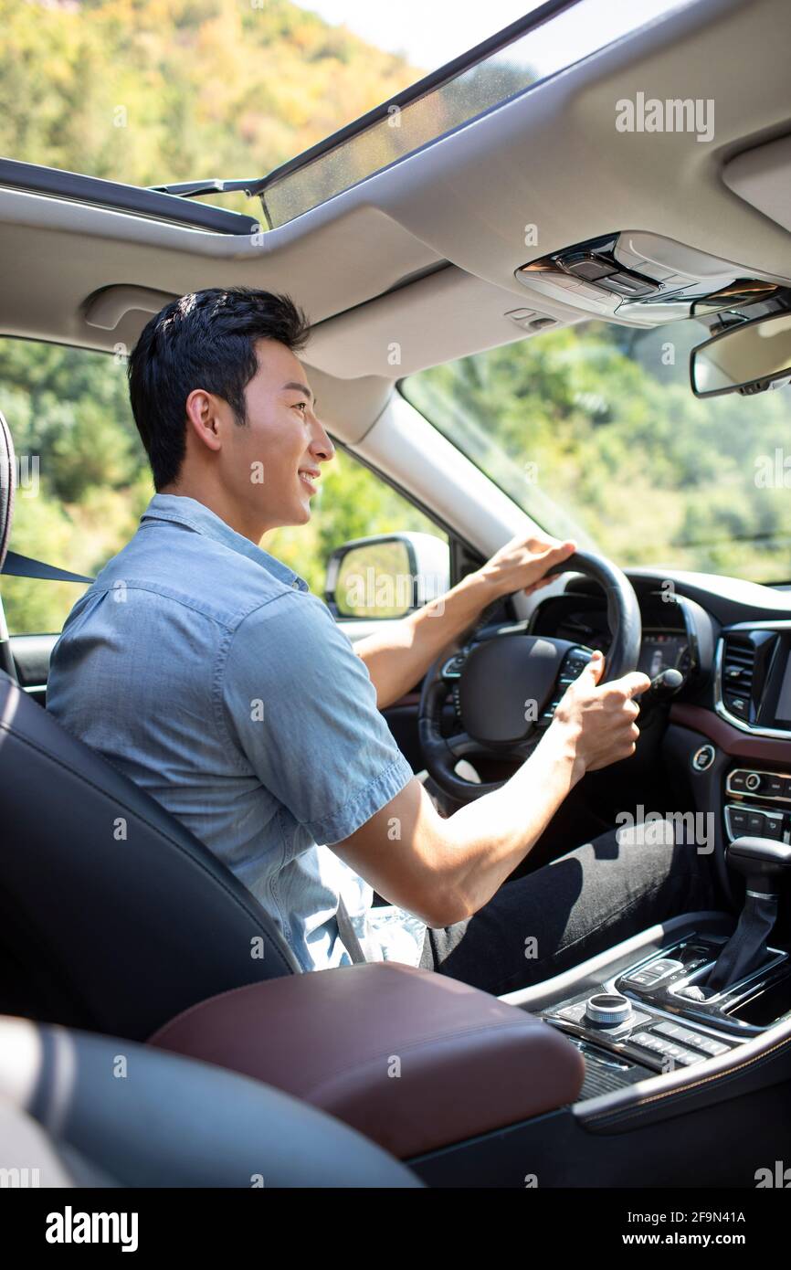 Happy young man enjoying road trip Stock Photo - Alamy