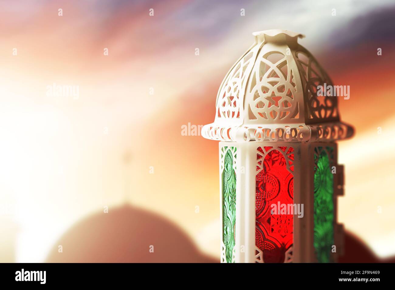 Arabic lamp with colorful light on the table with dramatic sky ...