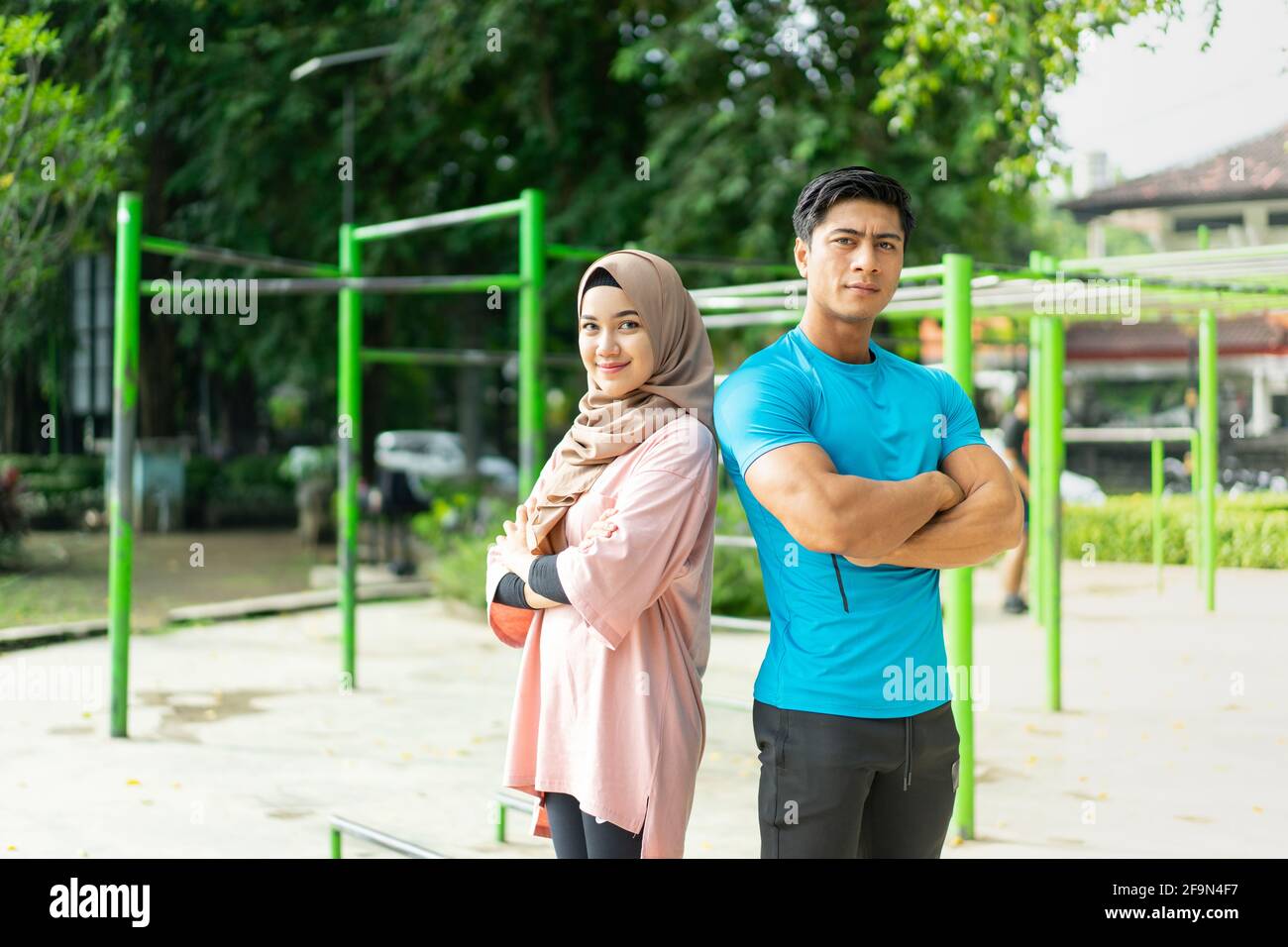 Muslim couples stand back to back with crossed hands Stock Photo - Alamy