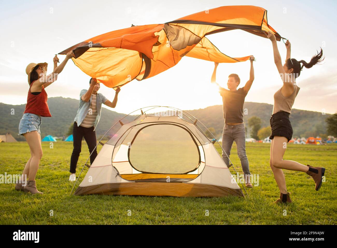 Happy young chinese friends camping hi-res stock photography and images ...