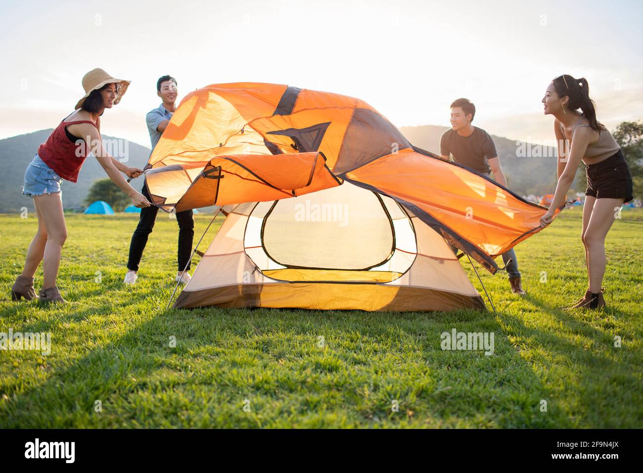 Happy young chinese friends camping hi-res stock photography and images ...