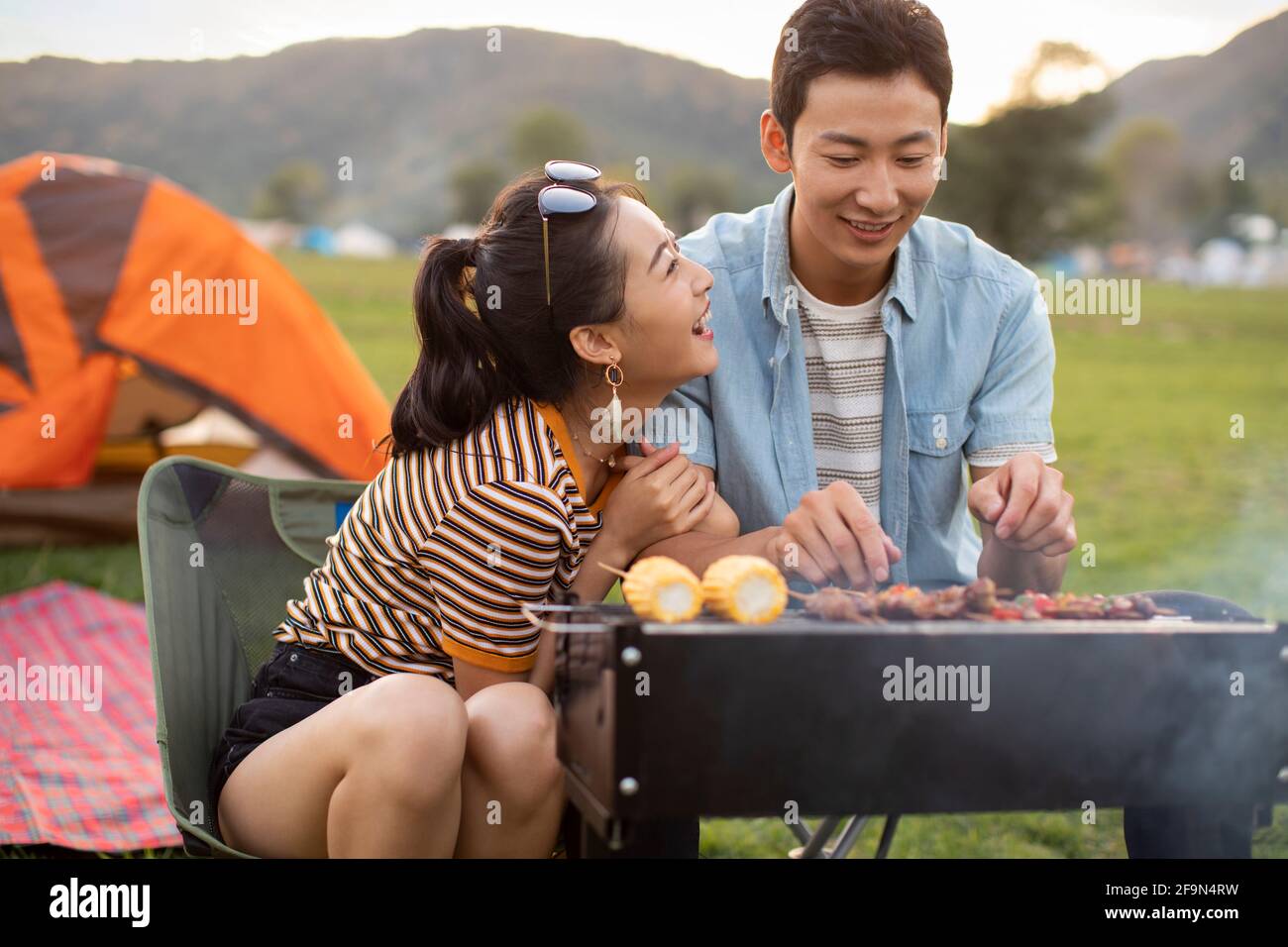 Happy young chinese couple barbecuing hi-res stock photography and ...