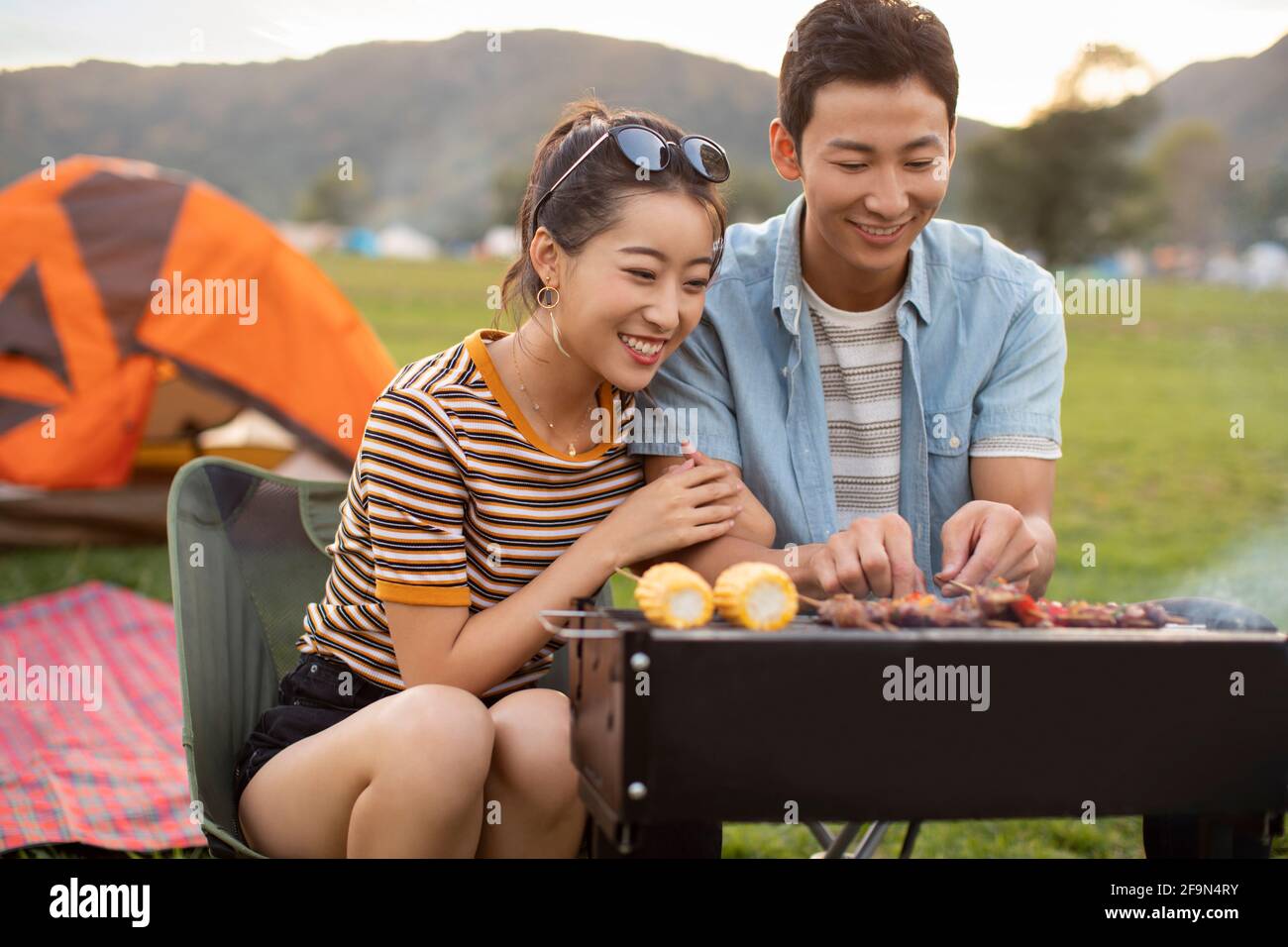 Happy young chinese couple barbecuing hi-res stock photography and ...