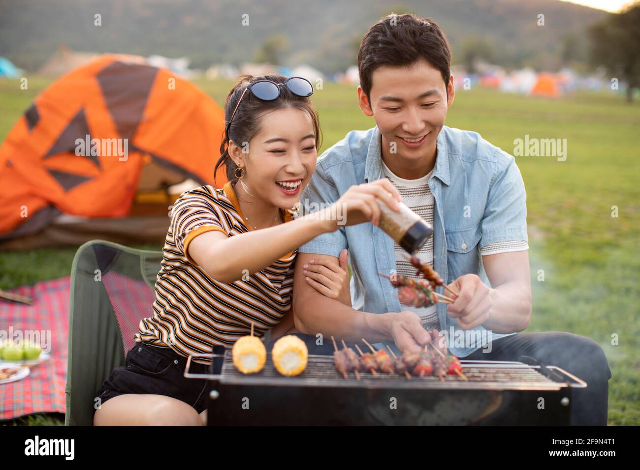 Happy young chinese couple barbecuing hi-res stock photography and ...