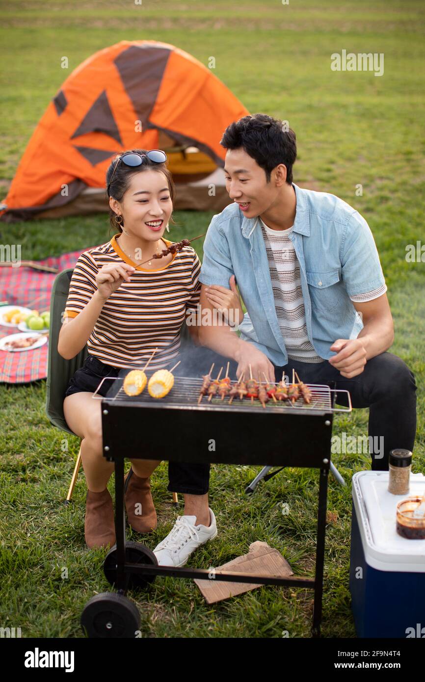 Happy young chinese couple barbecuing hi-res stock photography and ...