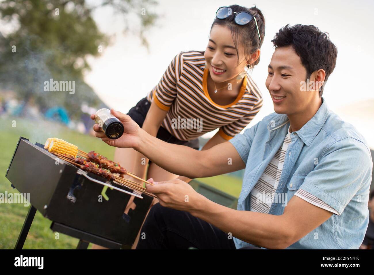 Young people barbecuing hi-res stock photography and images - Alamy