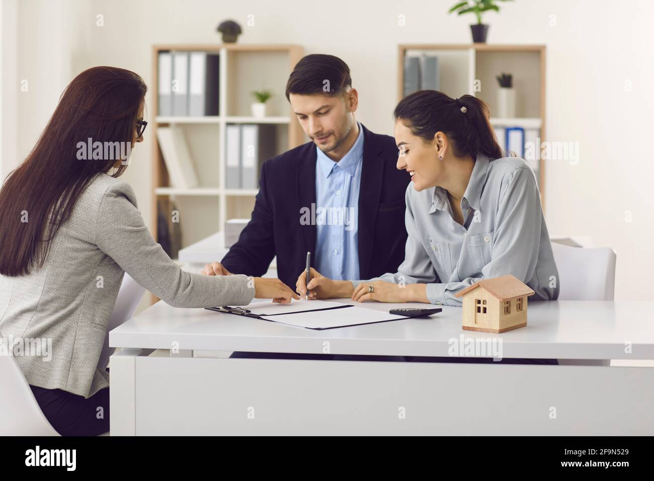 Family couple signing purchase agreement for house apartment at broker ...