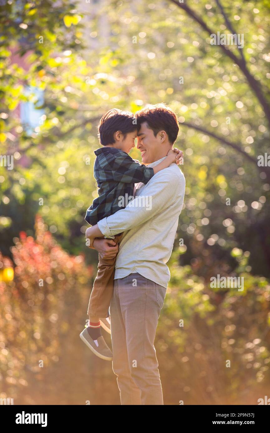 Happy father and son relaxing in park Stock Photo - Alamy