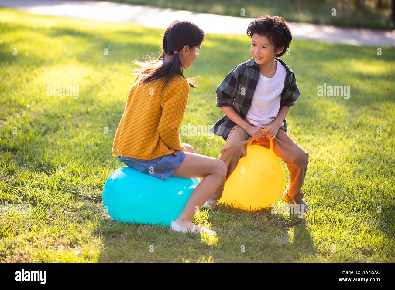 Happy children having fun in park Stock Photo - Alamy
