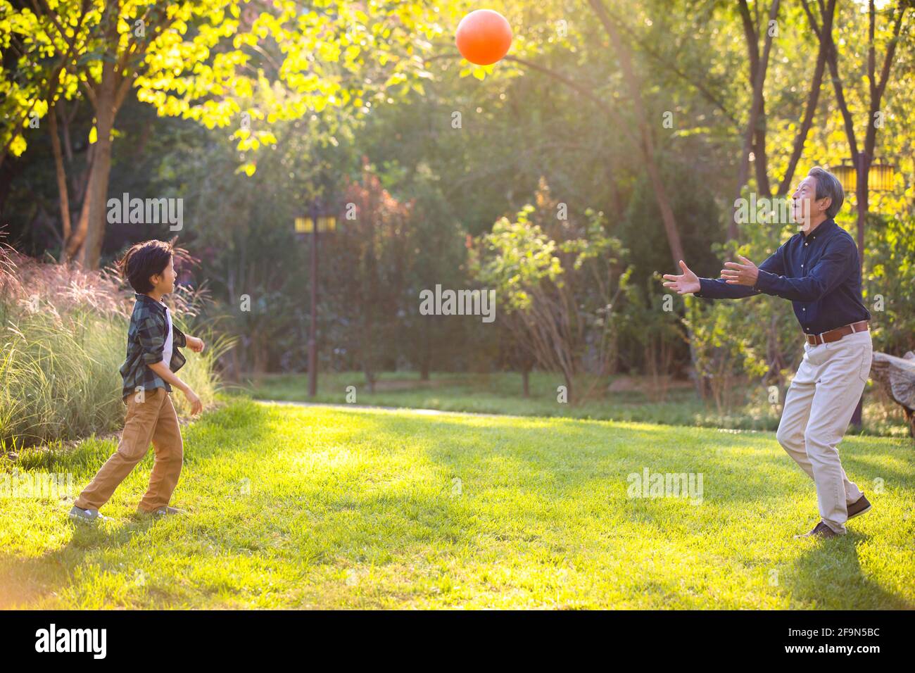 Happy grandfather and grandson having fun in park Stock Photo - Alamy