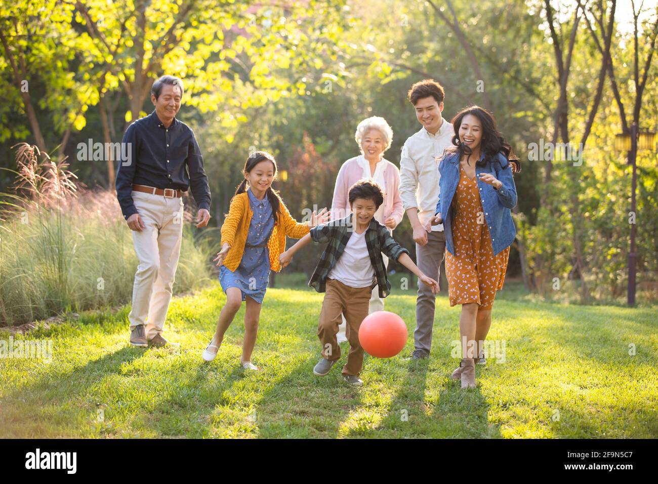 Happy family having fun in park Stock Photo - Alamy