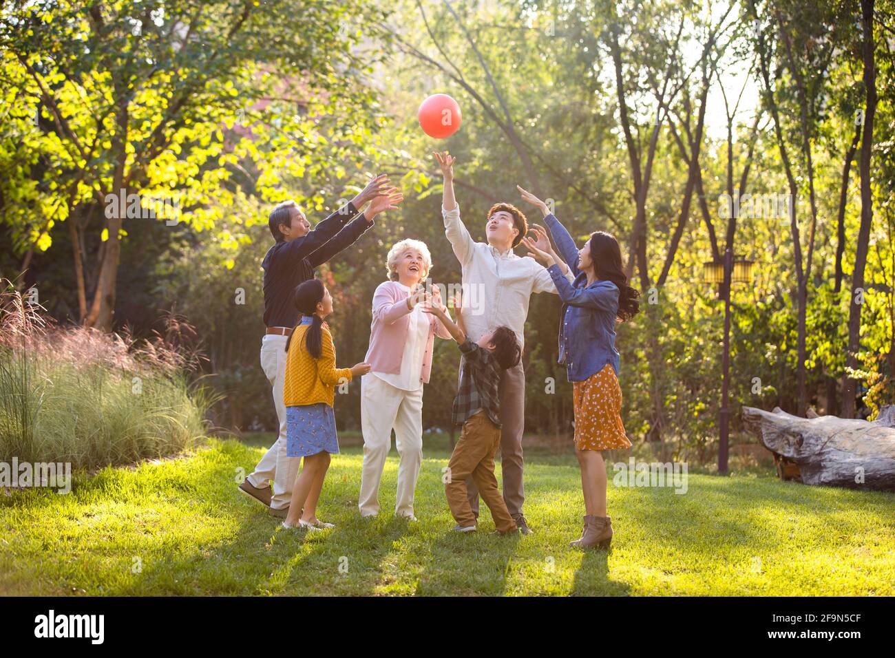 Happy family having fun in park Stock Photo - Alamy