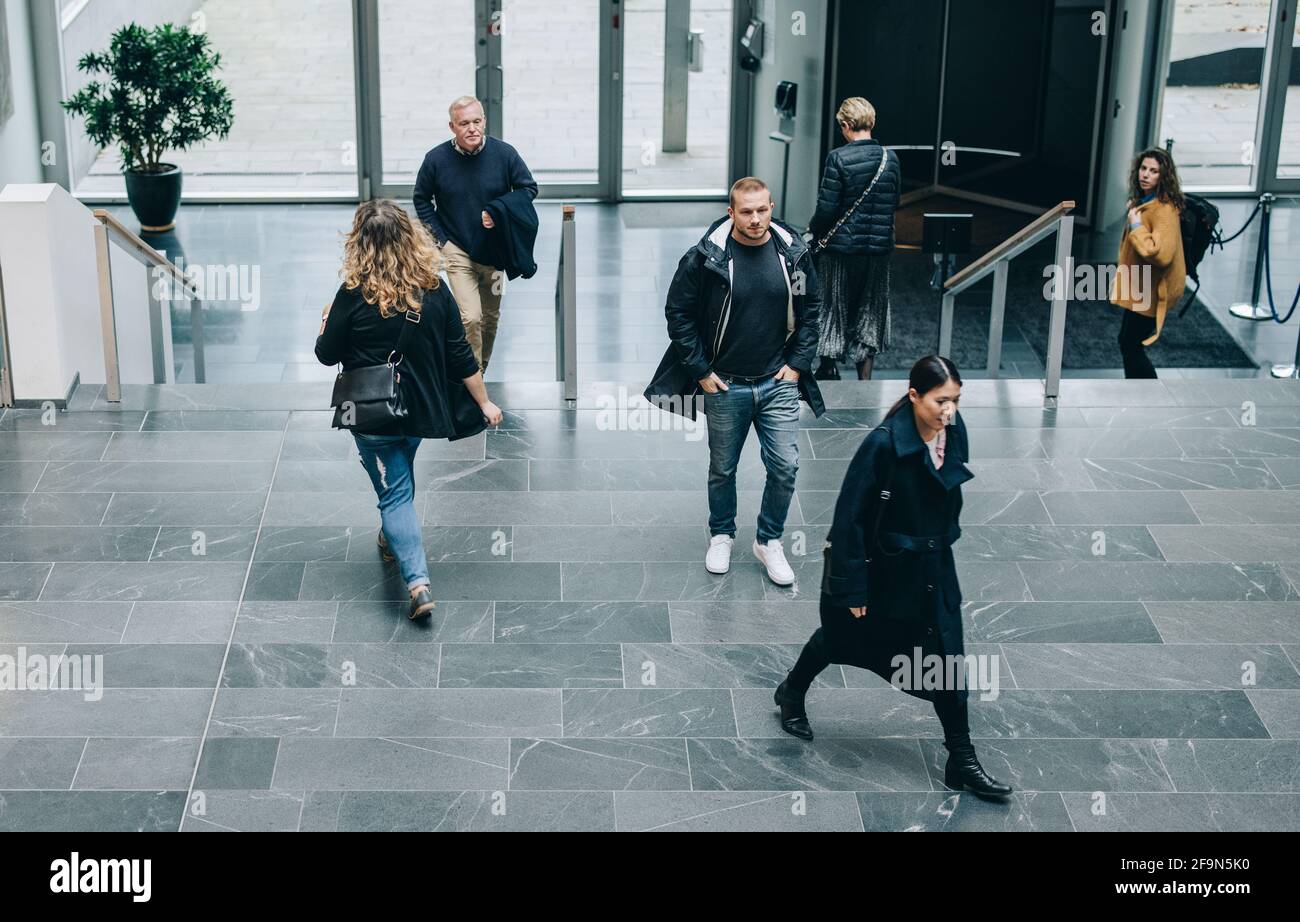 High angle view of business people in a lobby. business people walking ...