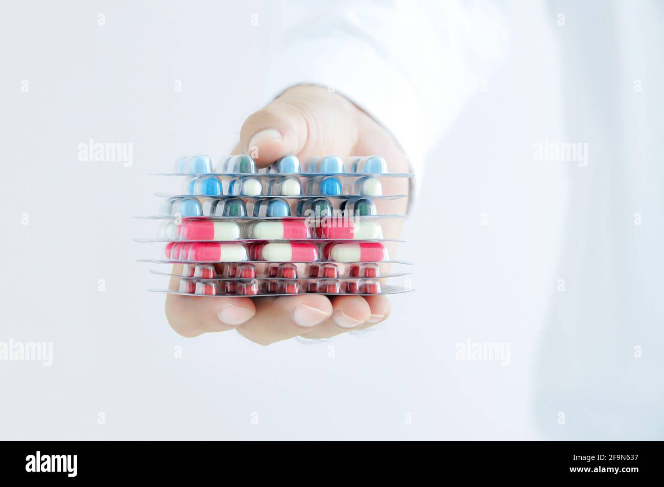 Hand holding medicines - capsules in blister packs Stock Photo - Alamy