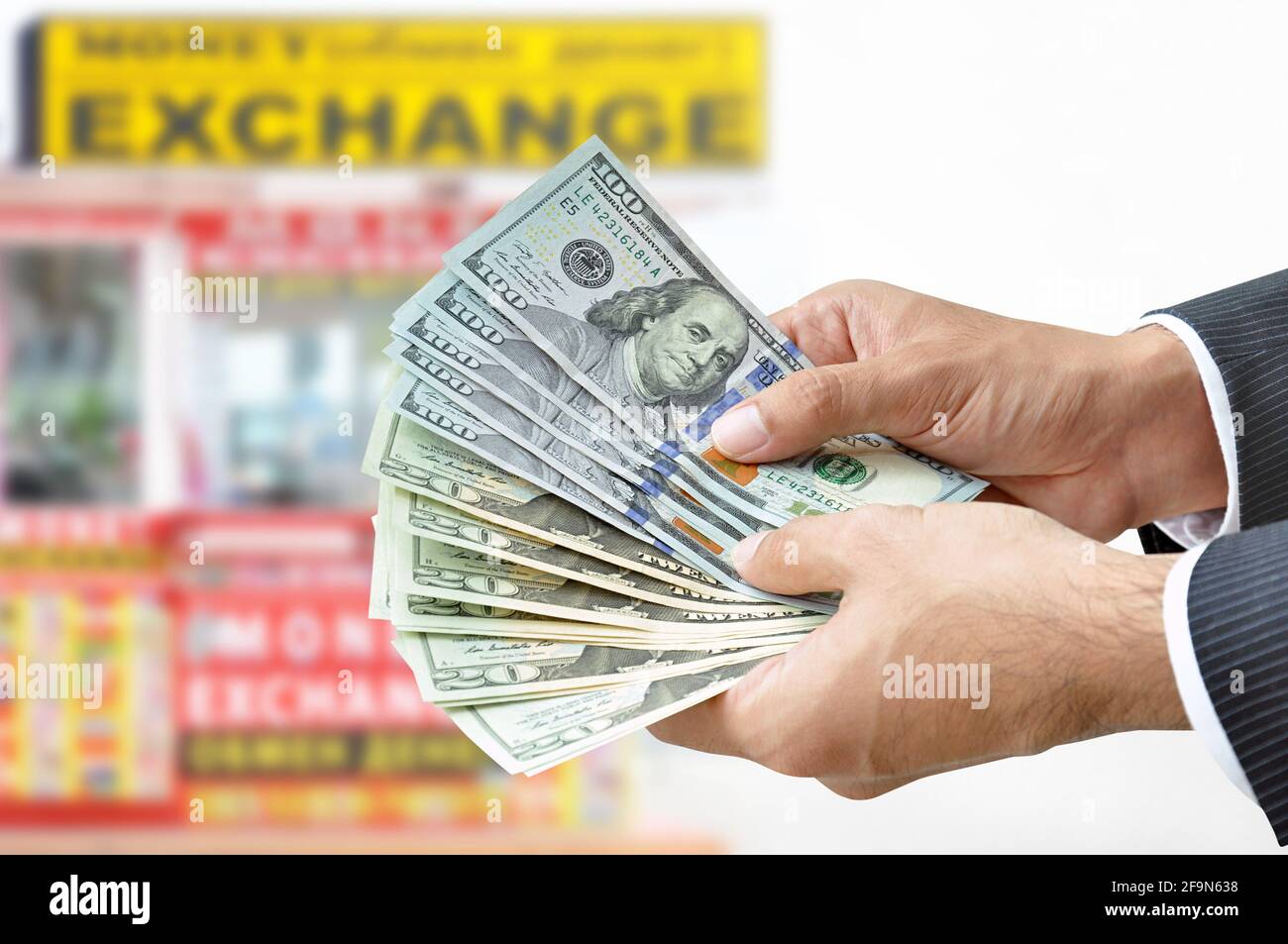 Hand holding US dollar bills - money exchange concept Stock Photo - Alamy