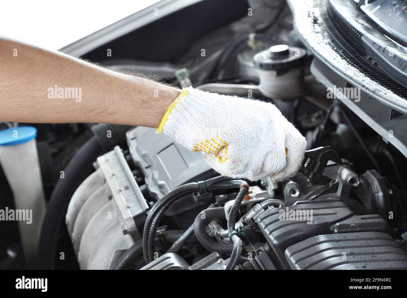 Hand with wrench repairing car engine Stock Photo - Alamy