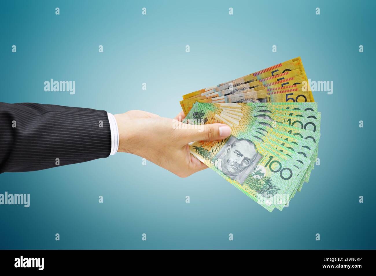 Hand holding money - Australian dollar (AUD) bills Stock Photo - Alamy