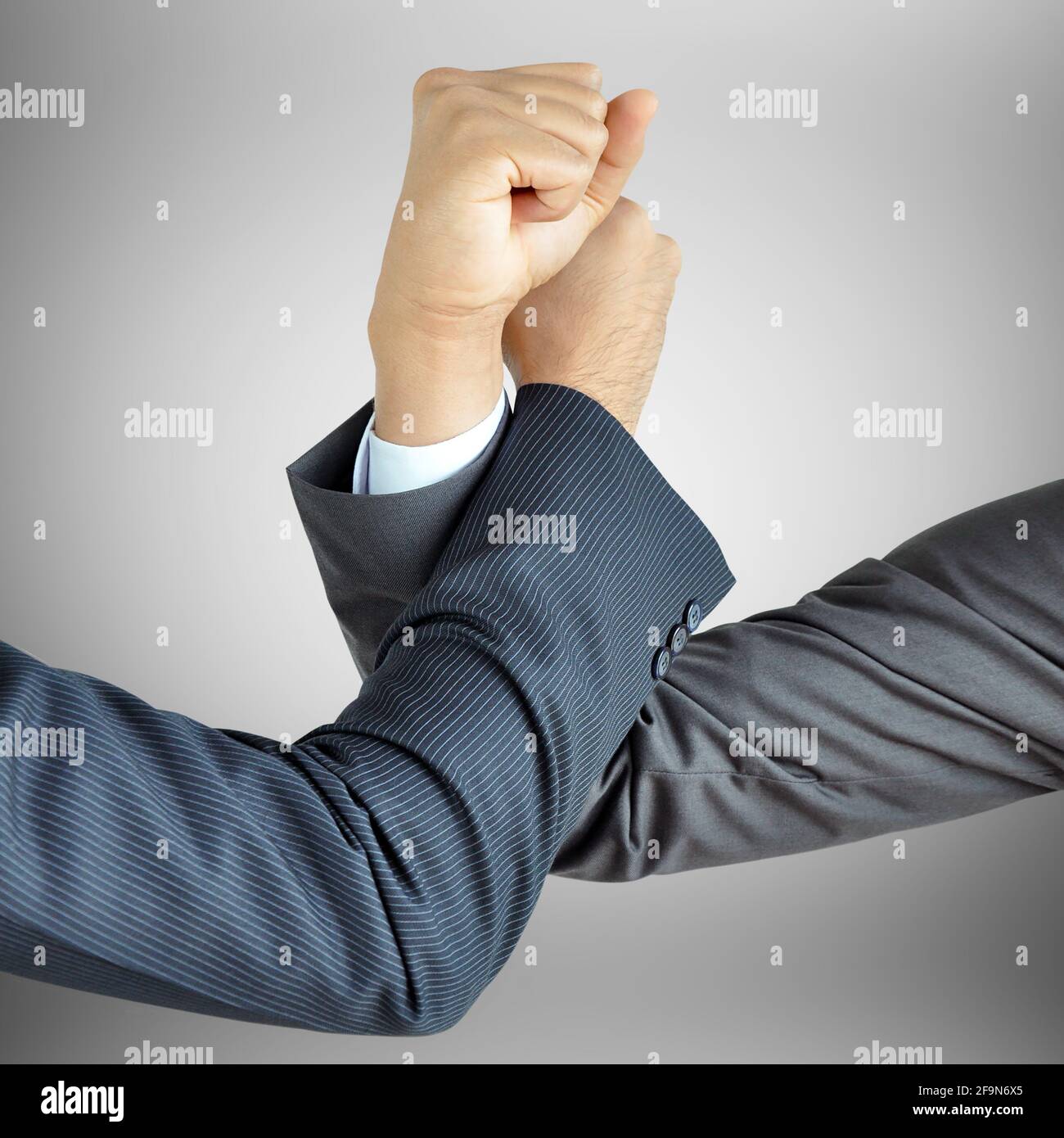 Businessman hands engage in arm wrestling Stock Photo - Alamy