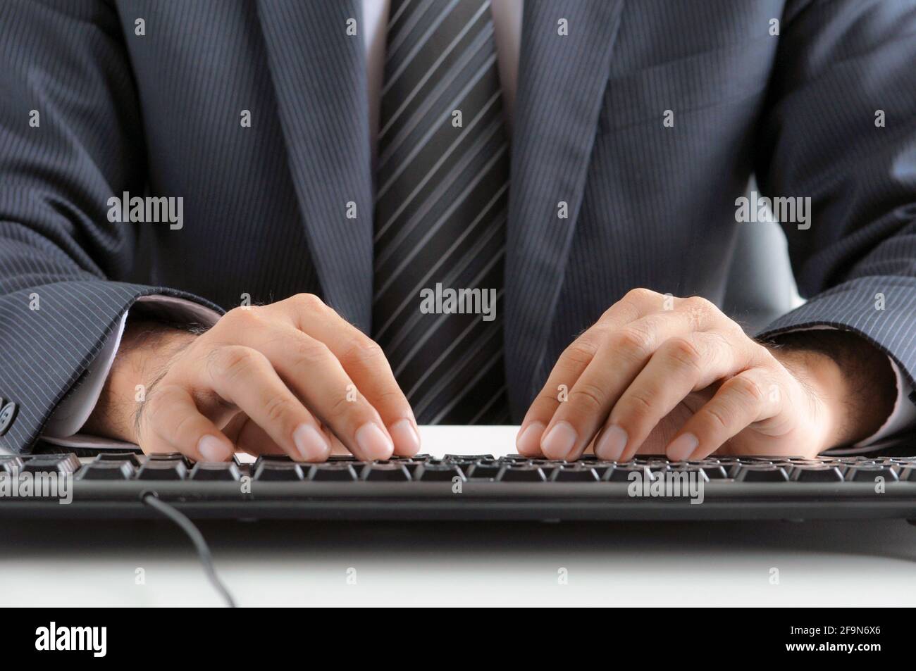 Businessman hands typing computer keyboard Stock Photo - Alamy