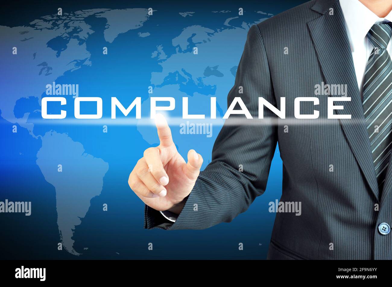 Businessman pointing to COMPLIANCE word on virtual screen Stock Photo ...