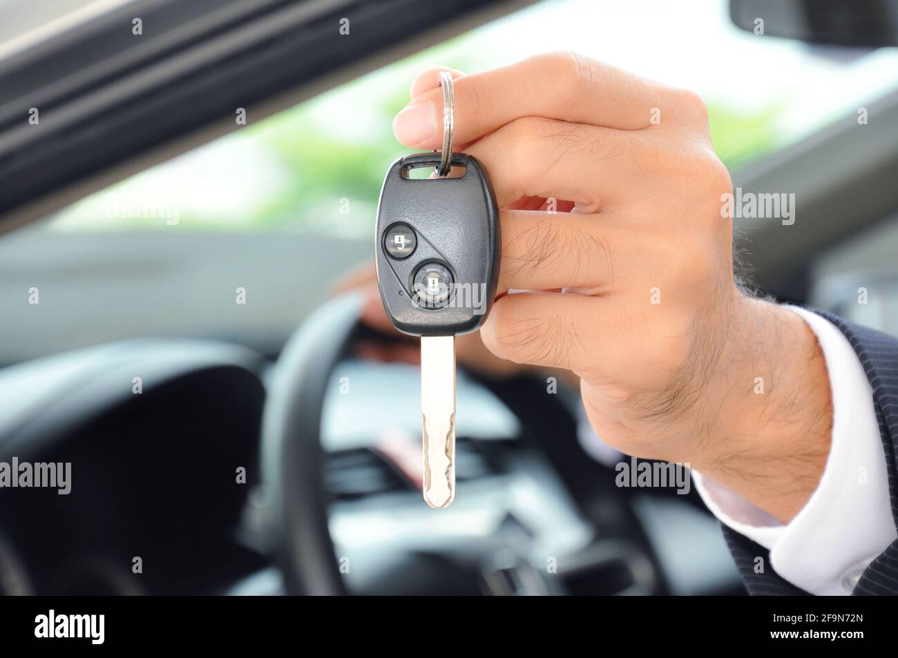 Hand holding a car key - car sale & rental business concept Stock Photo ...