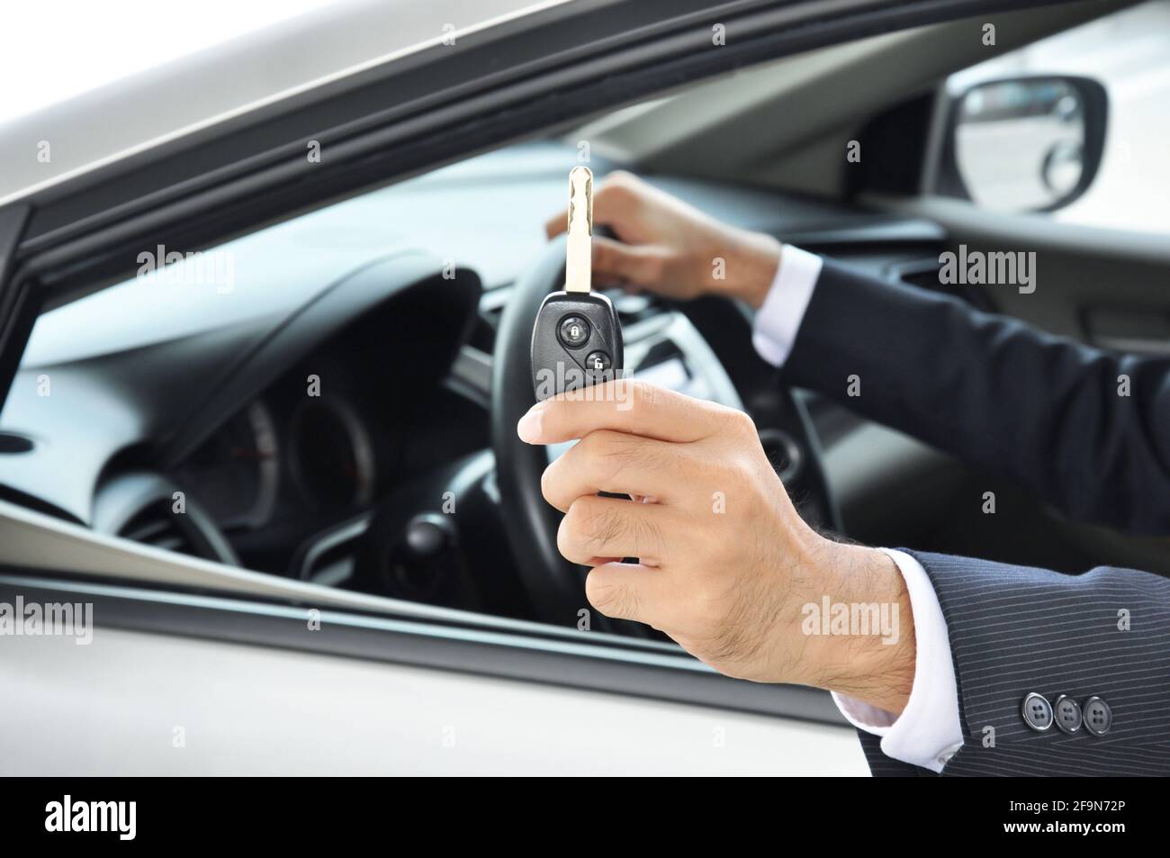 Hand holding a car key - car sale & rental business concept Stock Photo ...