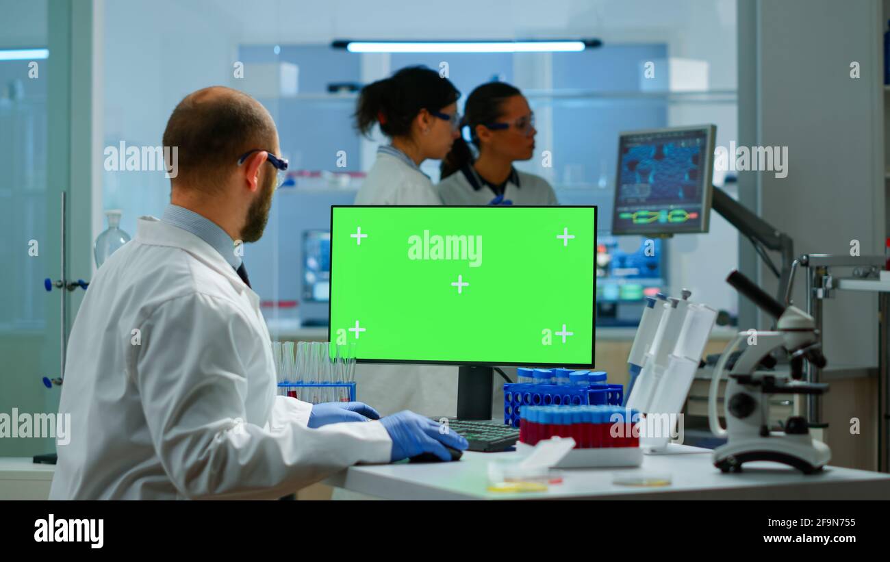 Man researcher looking at chroma key display in modern equipped lab ...