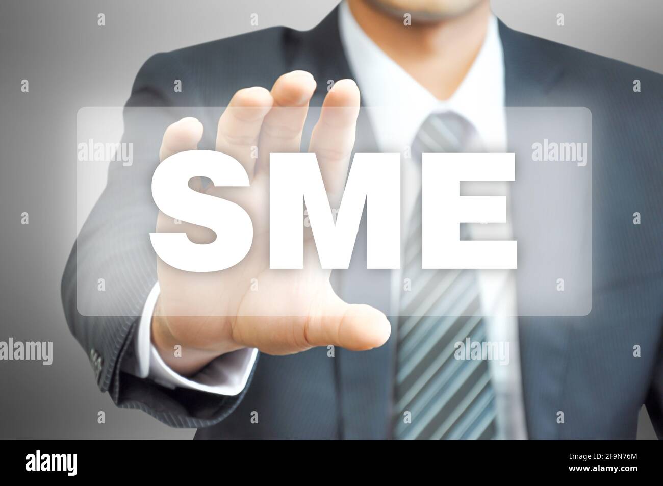 Businessman hand holding virtual screen with SME sign Stock Photo - Alamy