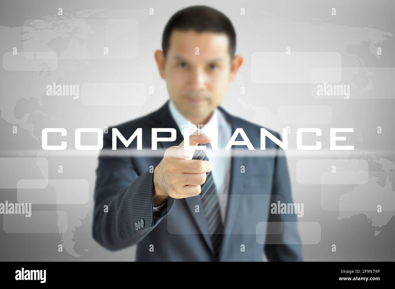 Businessman pointing to COMPLIANCE word on virtual screen Stock Photo ...