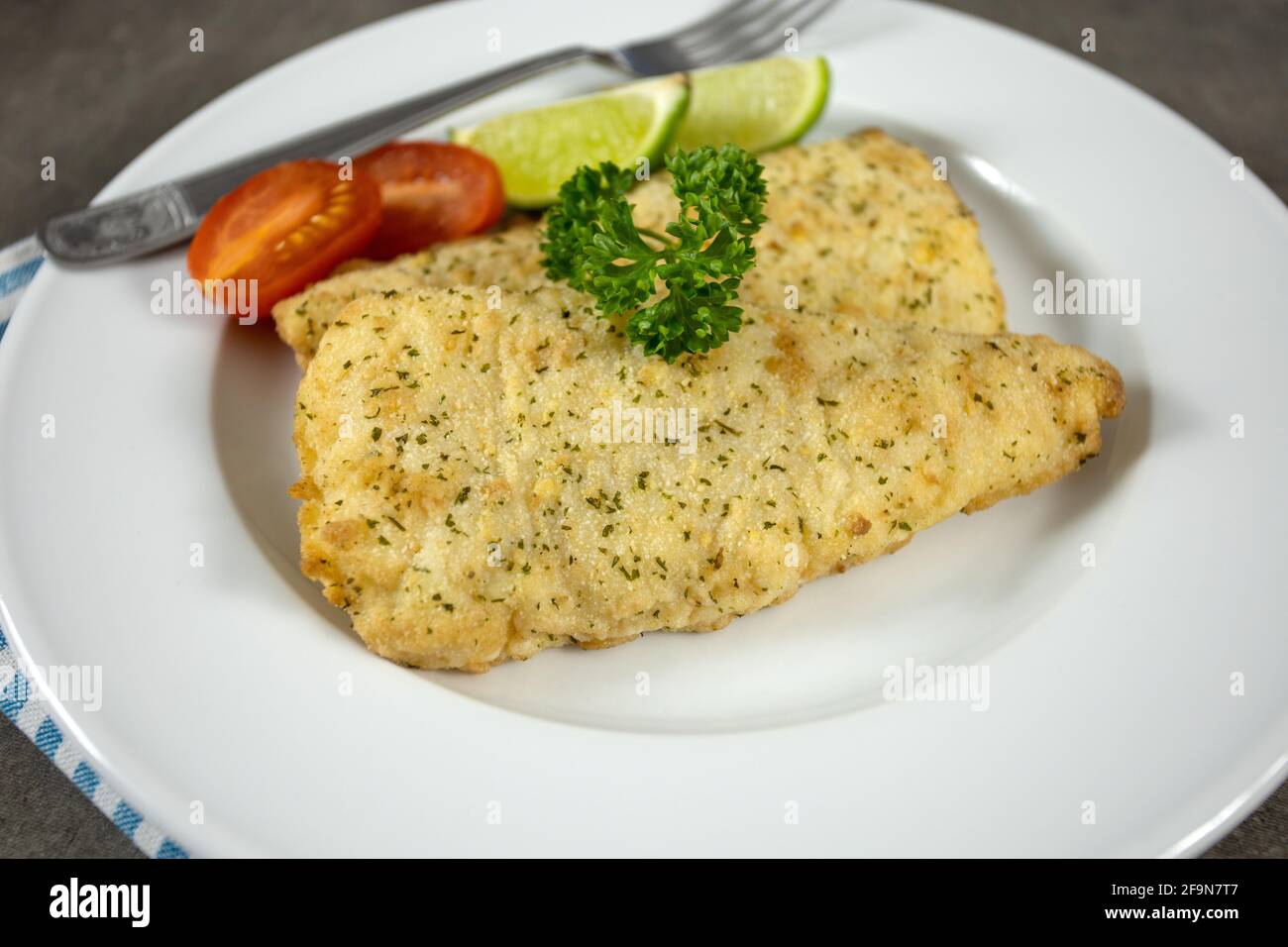 breaded fish in a white plate Stock Photo - Alamy