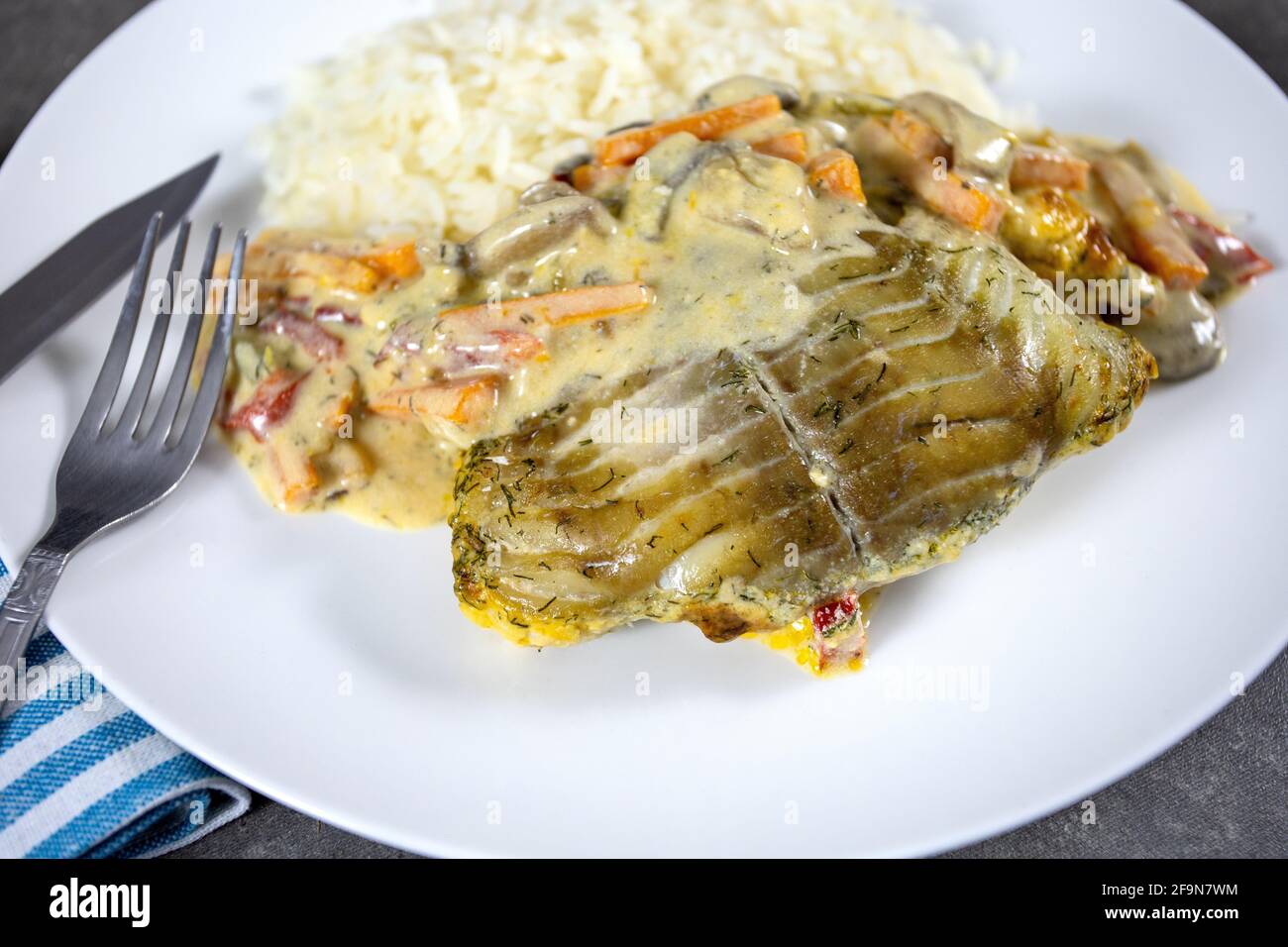 white fish with rice on a plate Stock Photo - Alamy