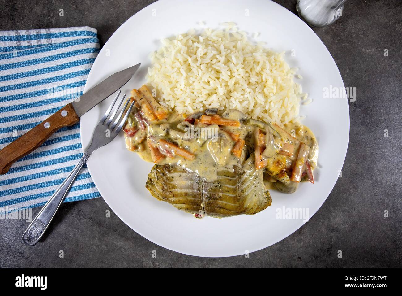 white fish with rice on a plate Stock Photo - Alamy