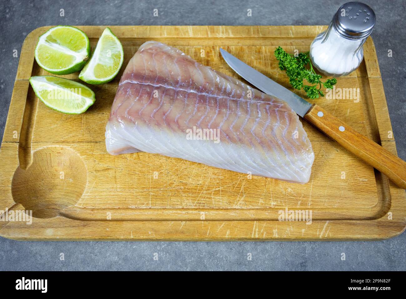 raw saithe fillet on a wooden board Stock Photo - Alamy