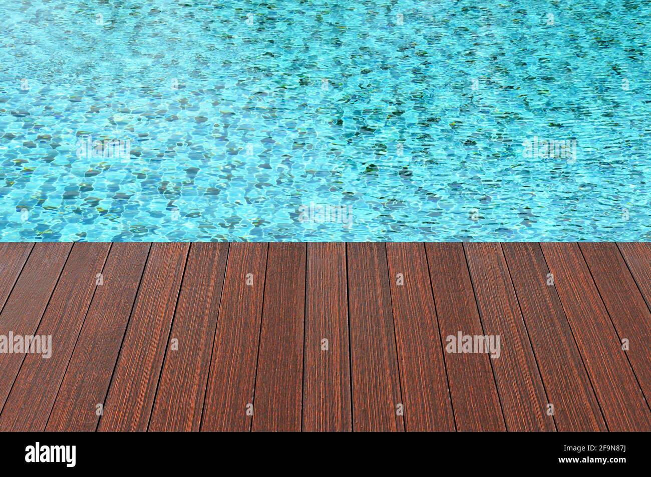 Wood plank on swimming pool water background Stock Photo - Alamy