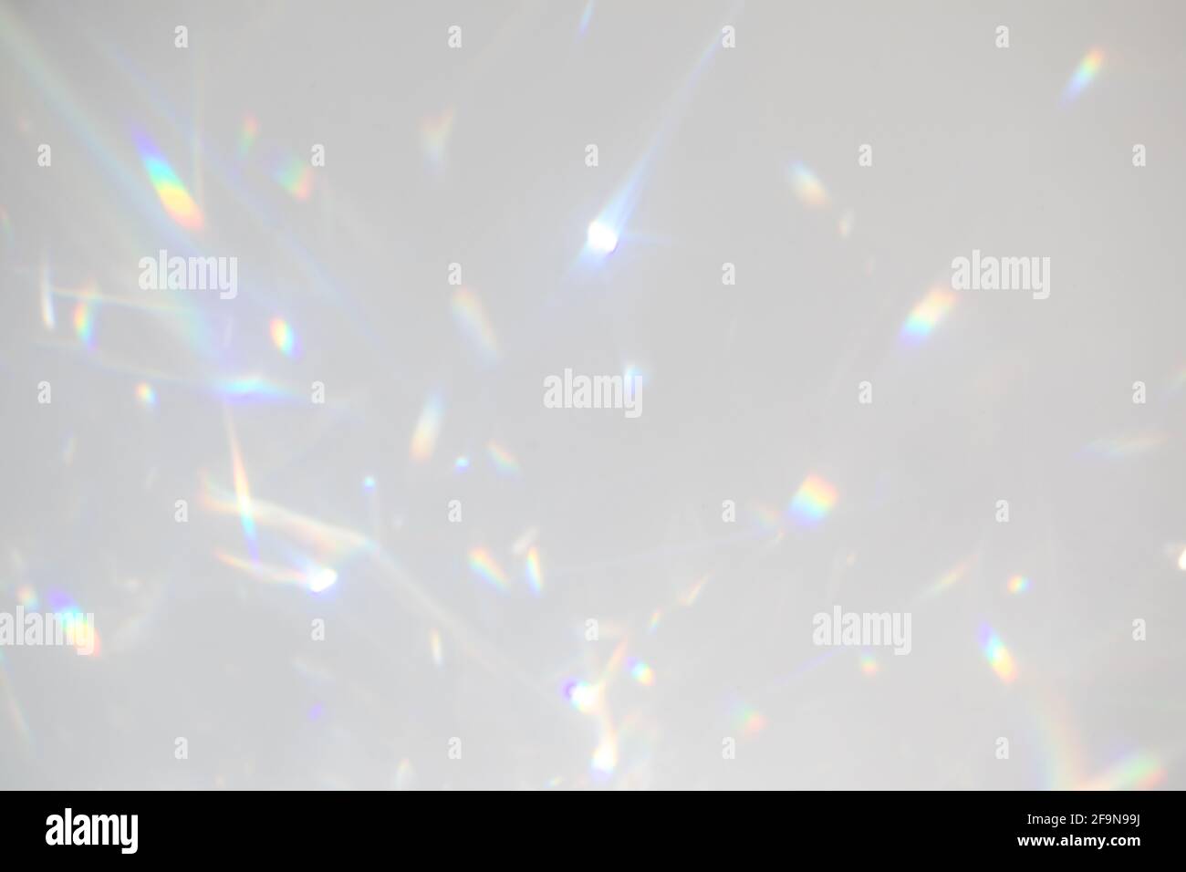 Blurred rainbow light refraction texture on white wall Stock Photo - Alamy