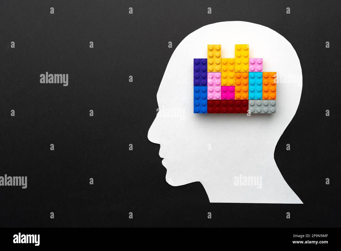 Papercut silhouette of human head with colorful constructor pieces ...