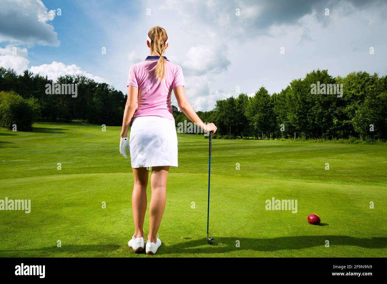 Young female golf player on course, she presumably does exercise Stock ...