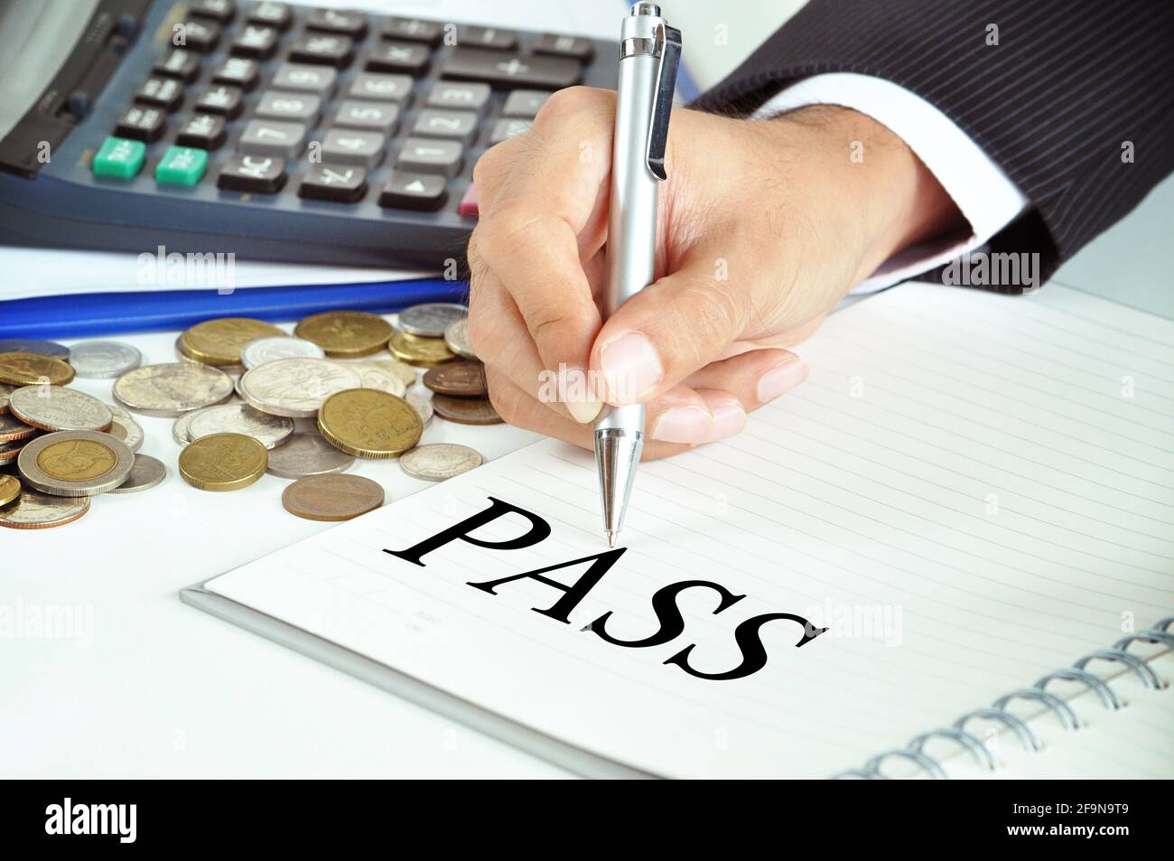 Businessman hand holding a pen pointing to PASS word on the paper Stock ...