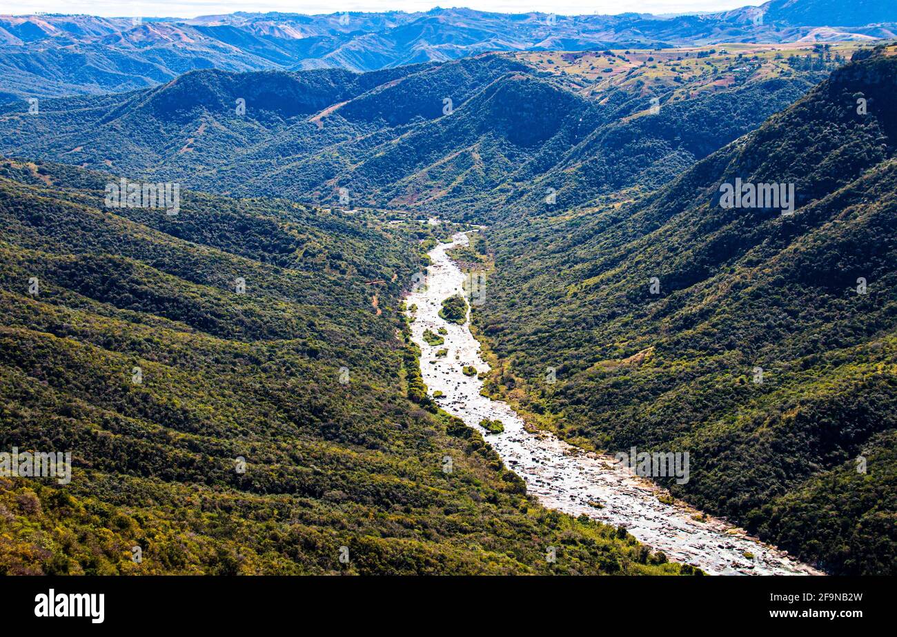 River flowing through steep tree lined valley Stock Photo - Alamy