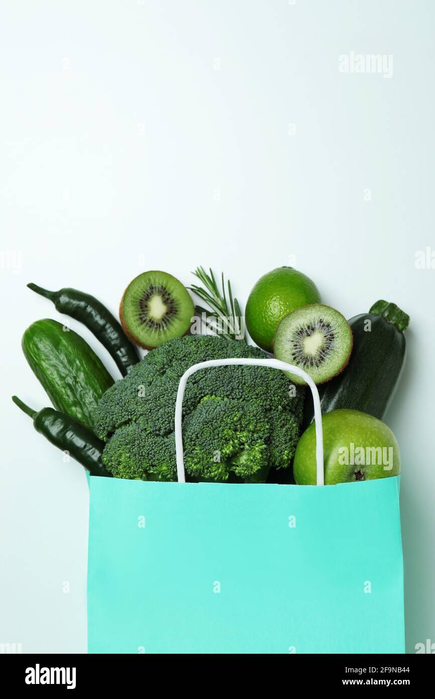 Paper bag with green vegetables on white background Stock Photo - Alamy