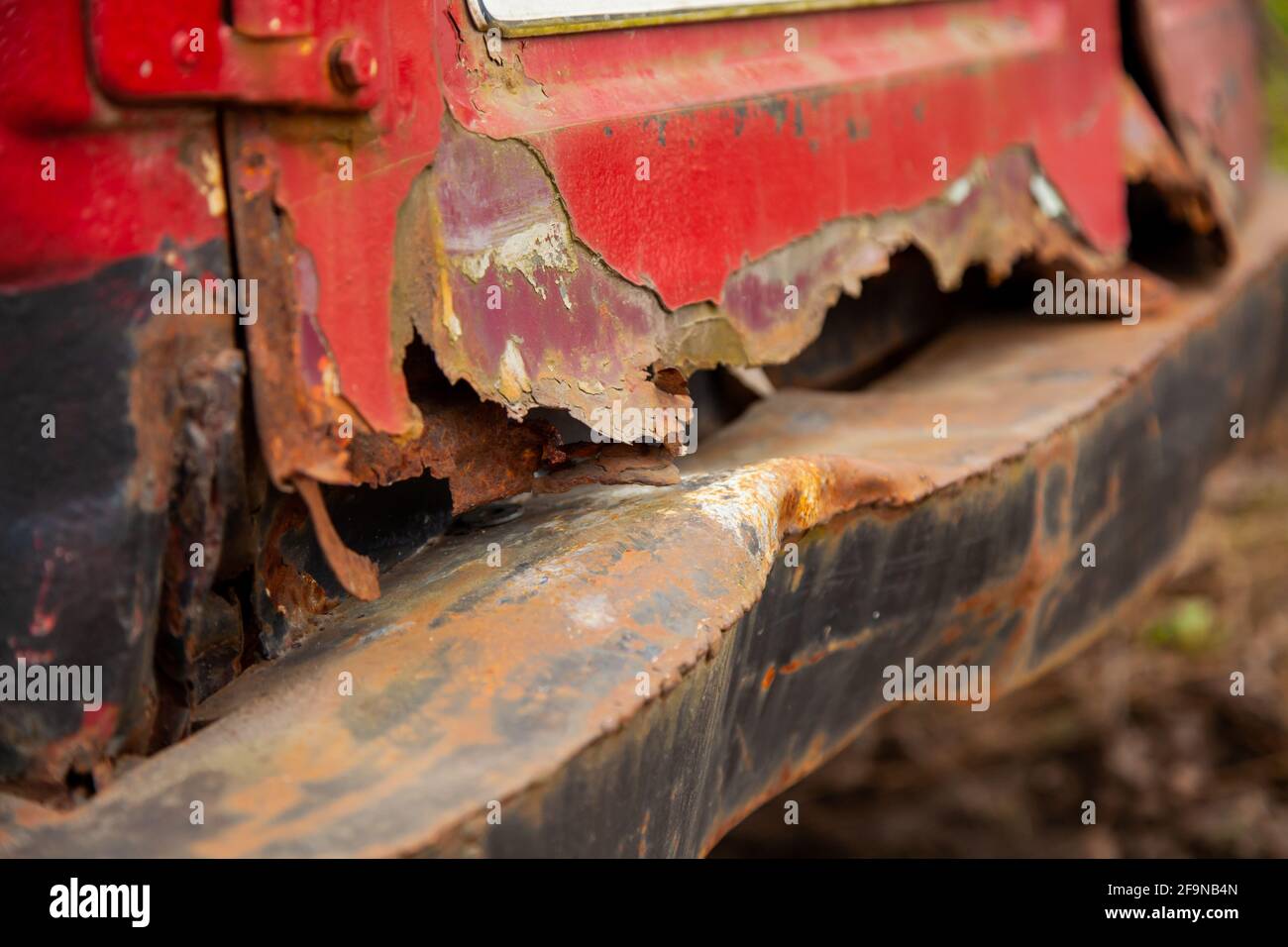 Rusty and bent back of the van. Old rusty bent rear bumper of a car ...