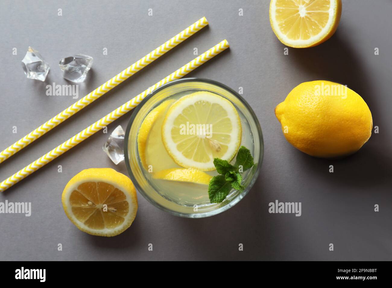 Glass of lemonade and ingredients on light gray background Stock Photo ...