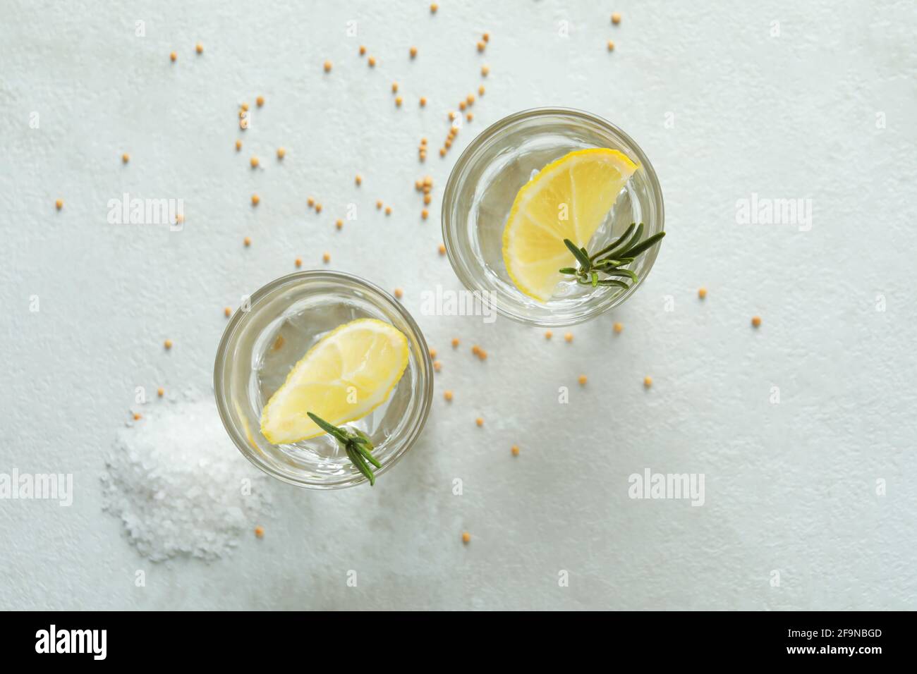 Shots of tequila on white textured table Stock Photo - Alamy