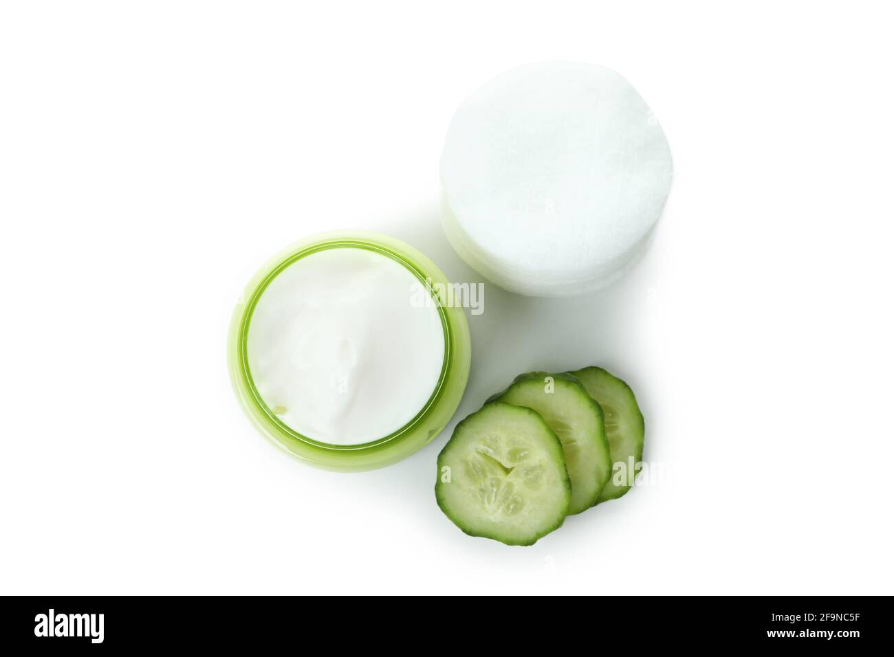 Cosmetic cream, cucumber slices and discs isolated on white background ...