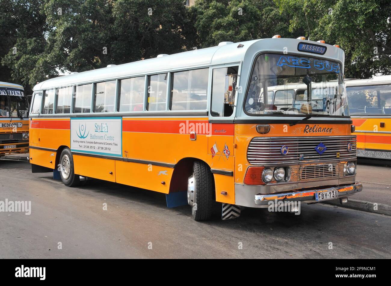 Traditional yellow buses urban transport on Valletta street, Malta ...
