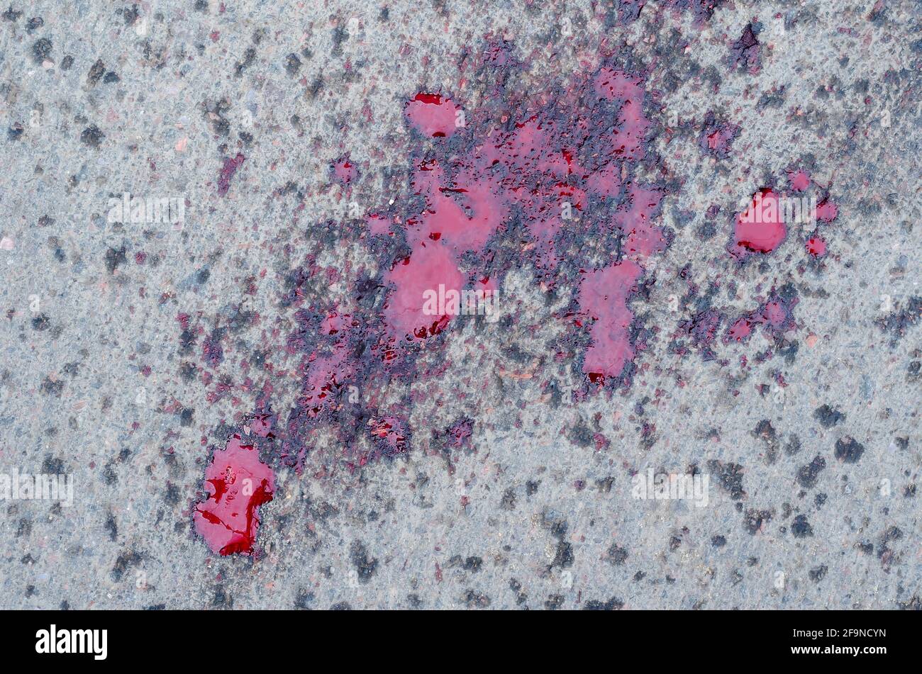 A pool of blood on the asphalt. Splattered human blood on the road. Top ...