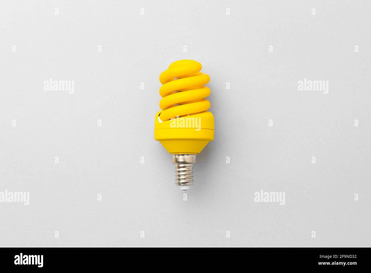 Light bulb on light grey paper background Stock Photo - Alamy
