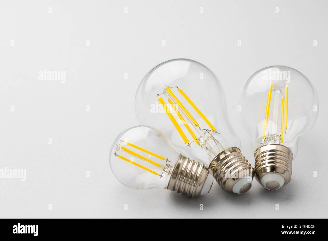 Light bulb on light grey paper background Stock Photo - Alamy