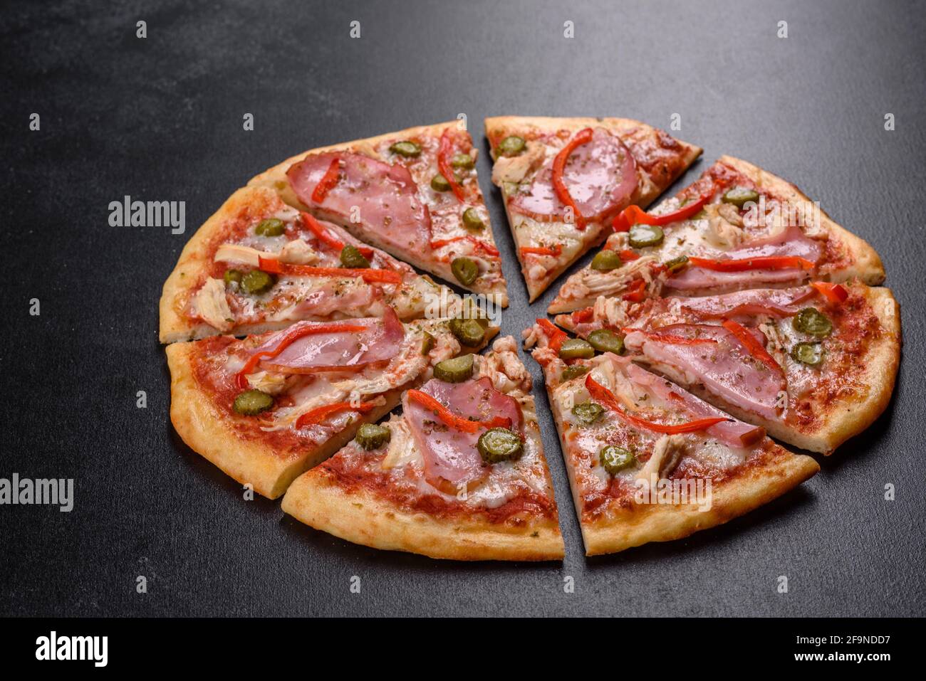 Delicious fresh crispy pizza from the oven with ham and Bulgarian ...